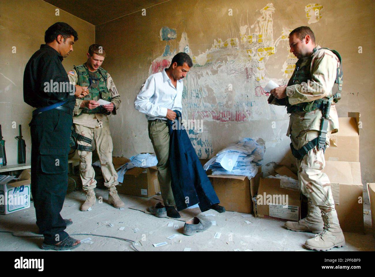 New Iraqi police recruits try on their uniforms at Al Nakhwa police ...
