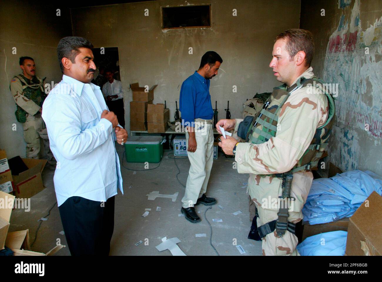 New Iraqi police recruits try on their uniforms at Al Nakhwa police ...