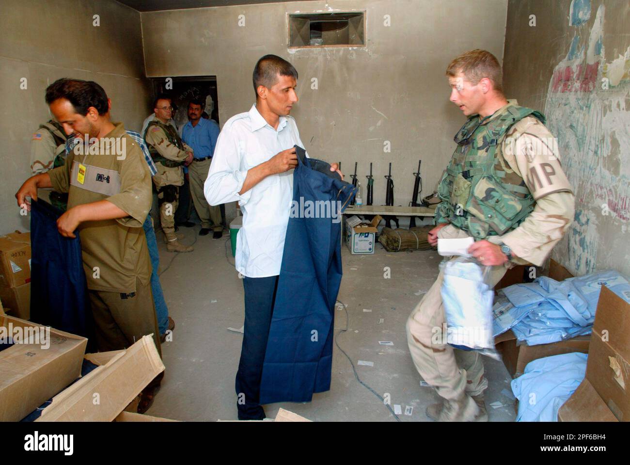 New Iraqi police recruits are fitted with their uniforms at Al Nakhwa ...