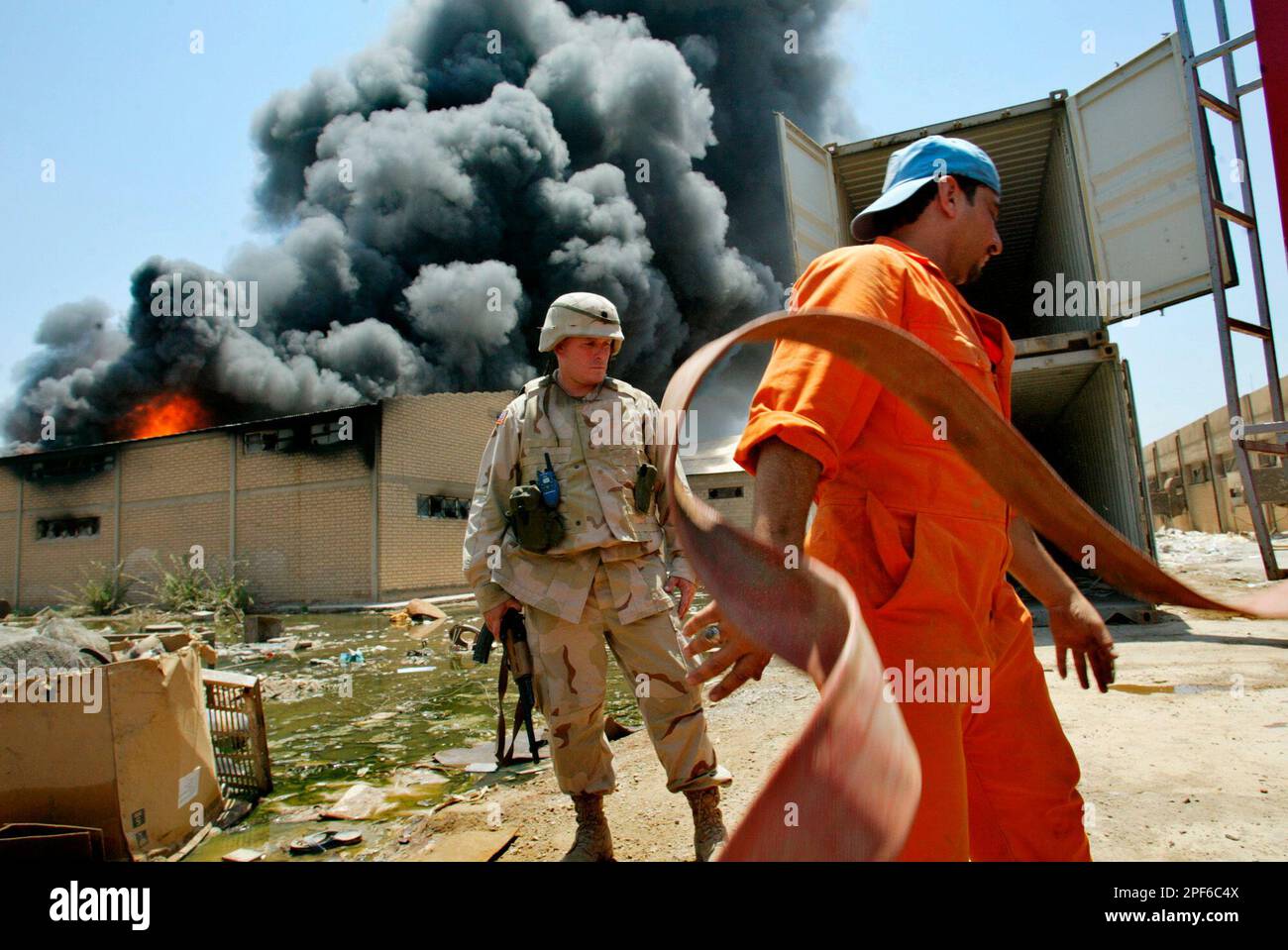 Lt. Col. Jim Otwell of Buffalo, N.Y, watches as an Iraqi firefighter ...
