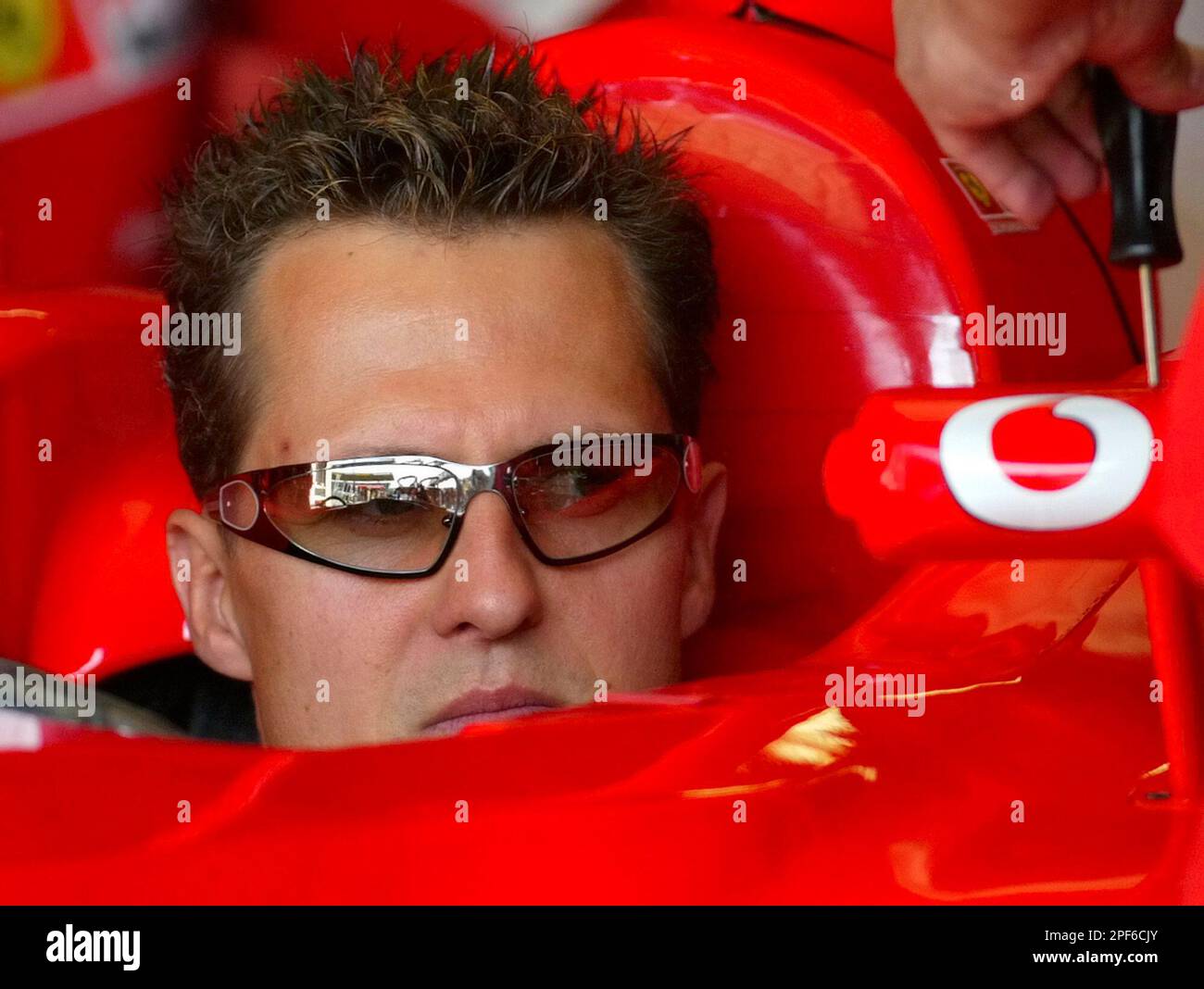 Germany's Formula One driver Michael Schumacher checks a rear mirror in ...