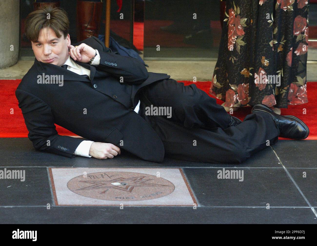 Mike Myers lies on the sidewalk with his star on the Canadian Walk of ...