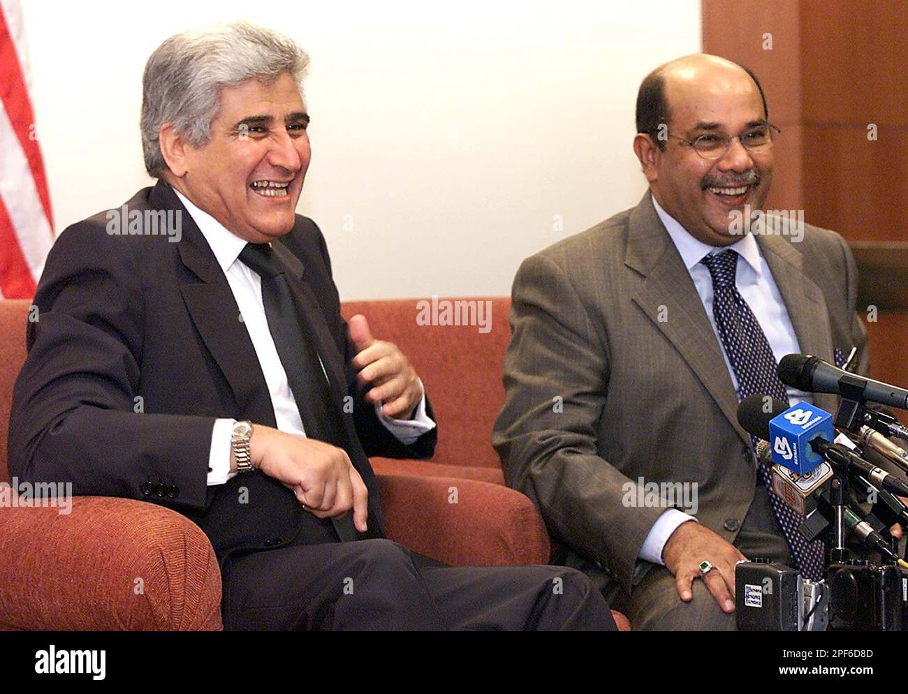Malaysian Foreign Minister Syed Hamid Albar, right, shares a light ...