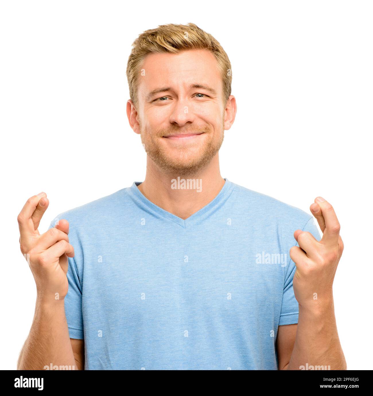 Finger and toes crossed. a handsome young man standing alone in the ...