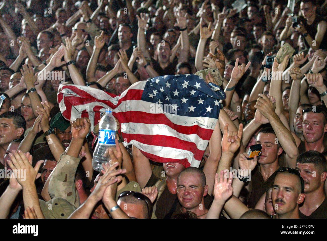 U.S. soldiers cheer during a performance of U.S. singer Kid Rock at a ...