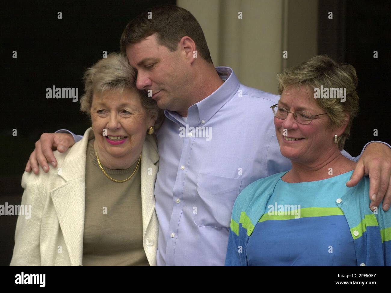 Chris Conover, center, 48, hugs his mother Diana Conover, left, while ...