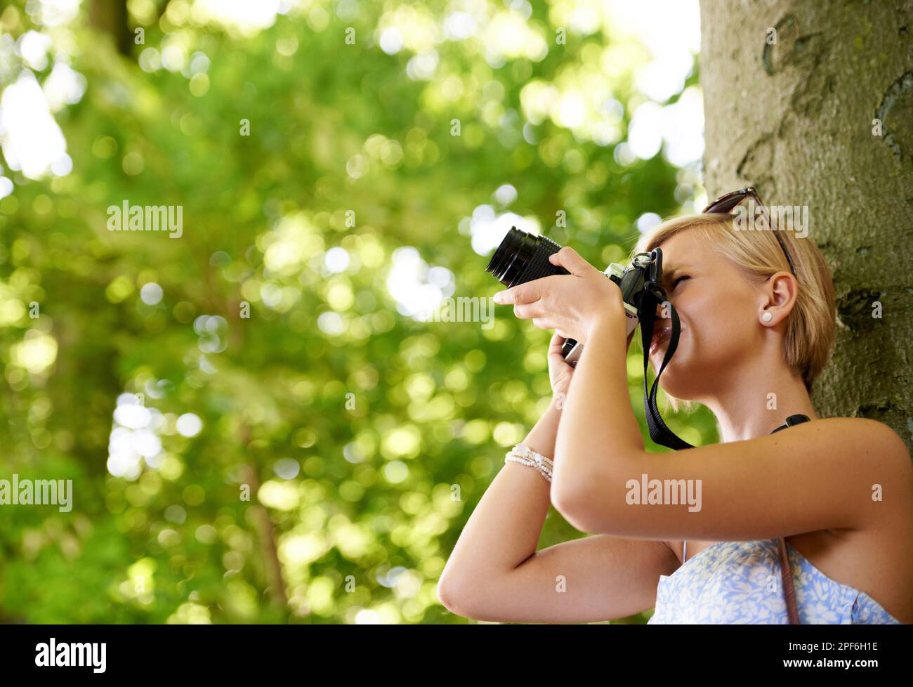 Waiting to capture the perfect image. an attractive young woman taking ...