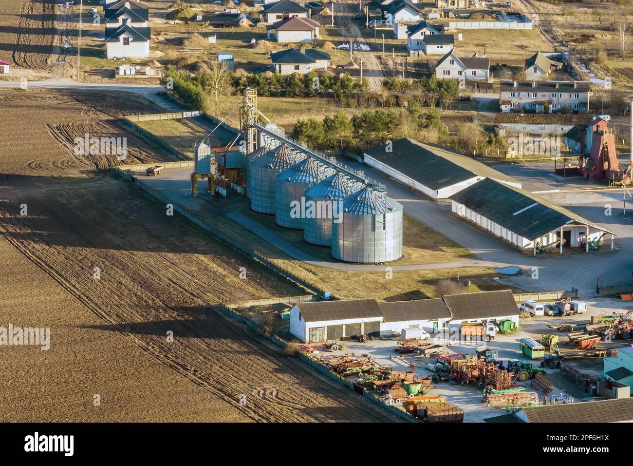 aerial view of agro-industrial complex with silos and grain drying line ...