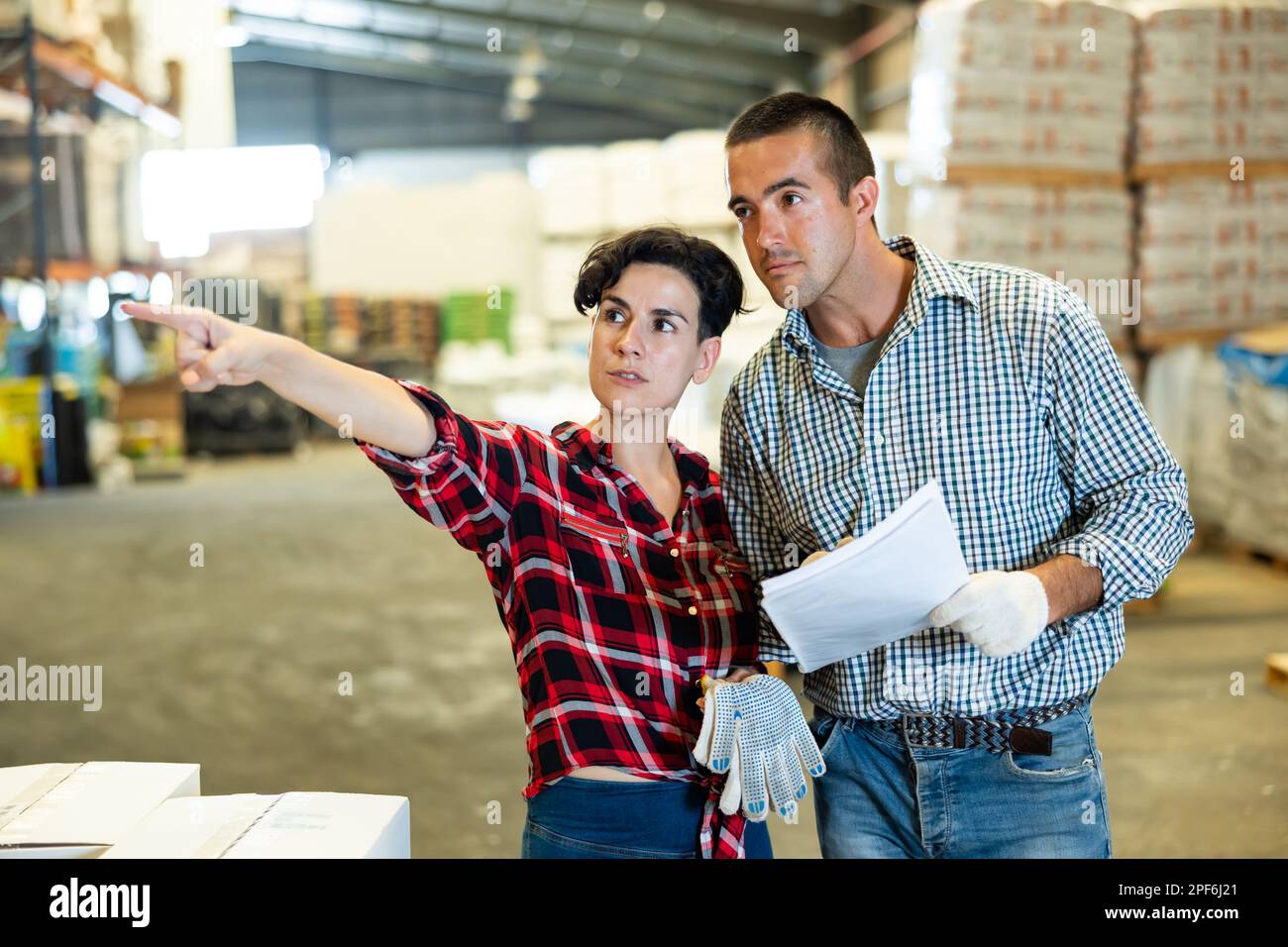 European male and female employees working at warehouse Stock Photo - Alamy