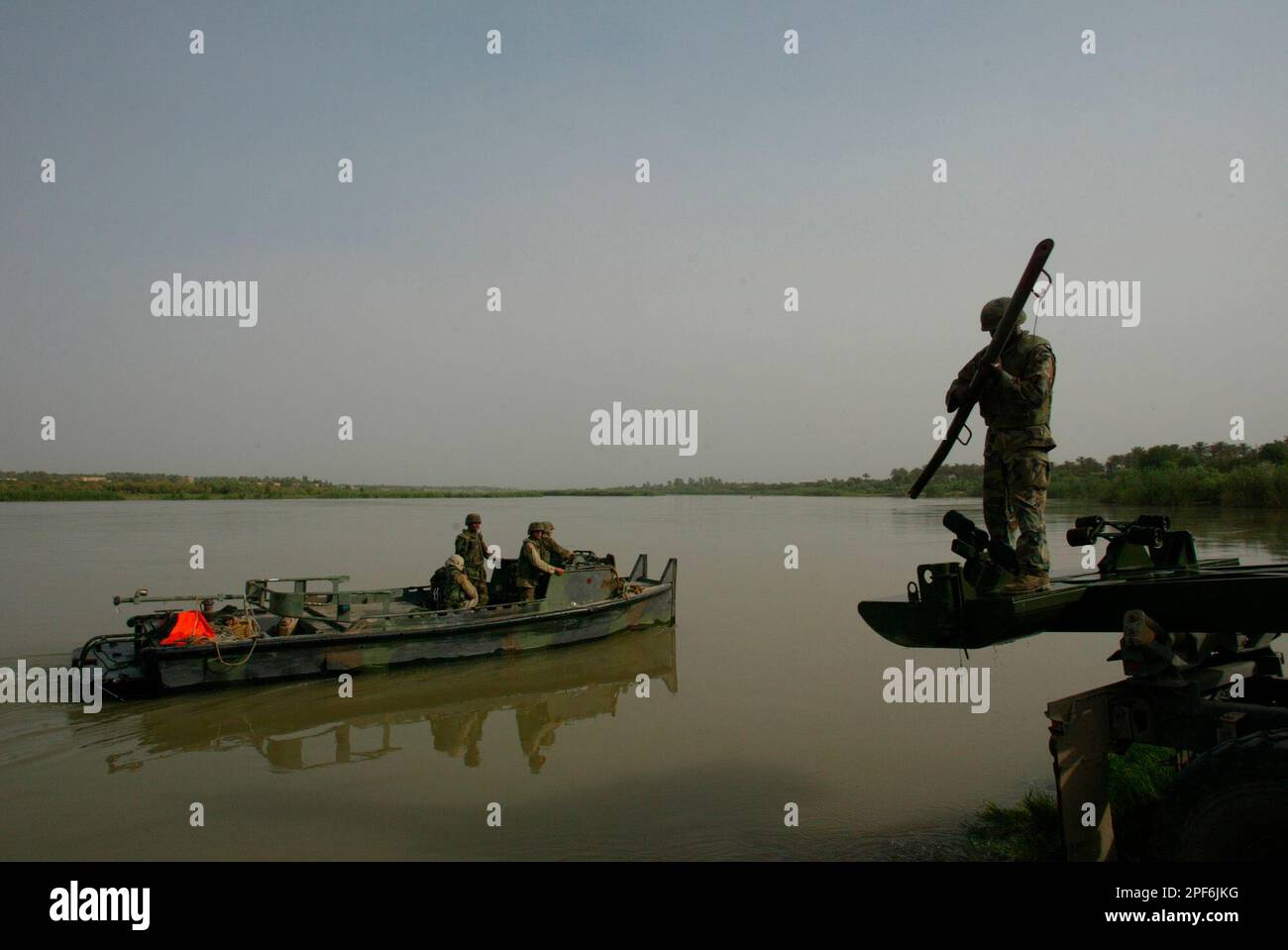 US soldiers return from a river patrol at Duluiyah, 45 miles north of ...