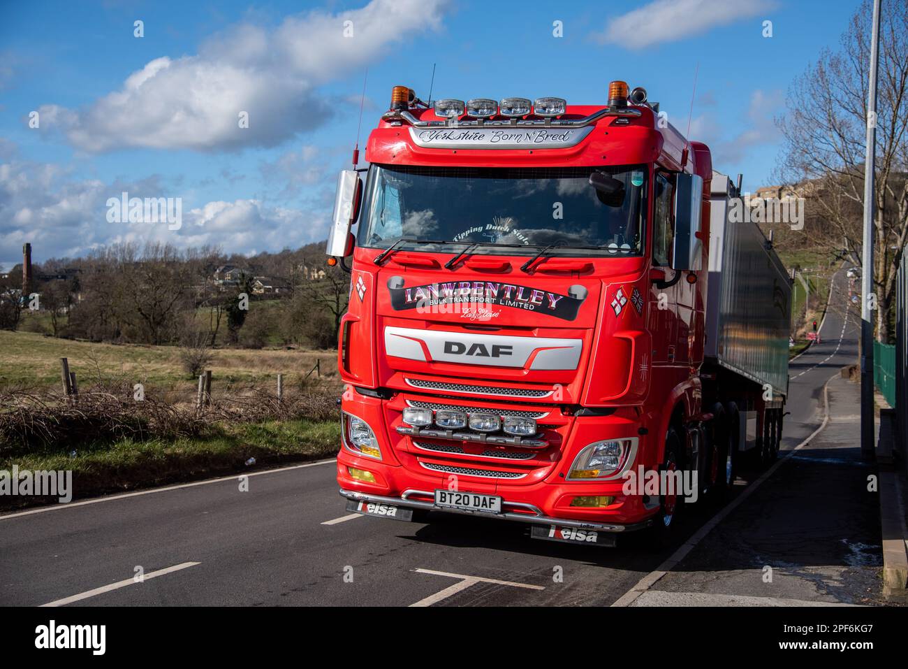 DAF XF heavy truck pulling a bulk tipper trailer parked on a narrow ...