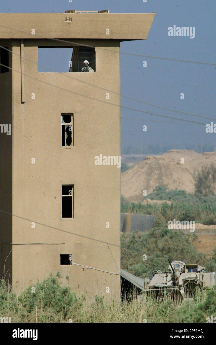 A US soldier guards one of the towers of the nuclear facility in ...