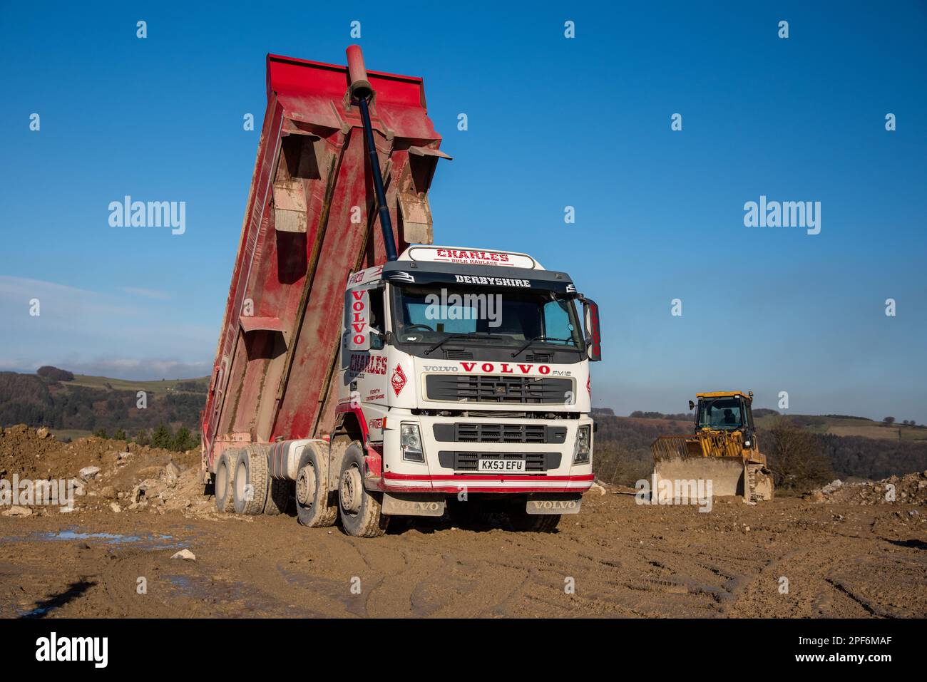 An older Volvo eight wheel bulk tipper unloading at a quarry site in ...