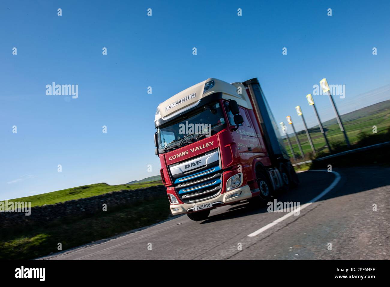 DAF truck pulling a curtainsider trailers on a tight corner on the the ...