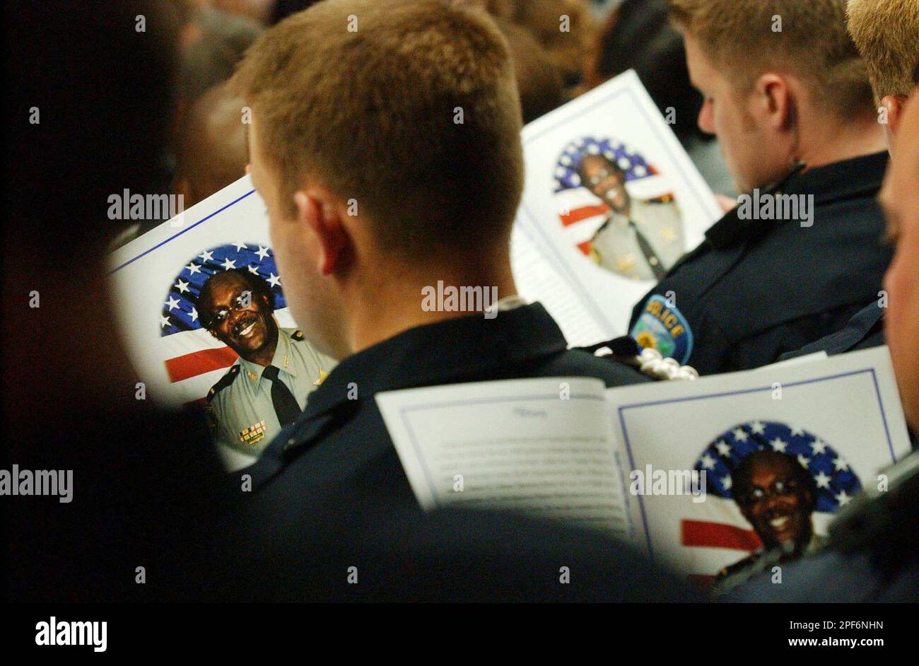 Local and statewide law enforcement officers hold programs bearing a ...