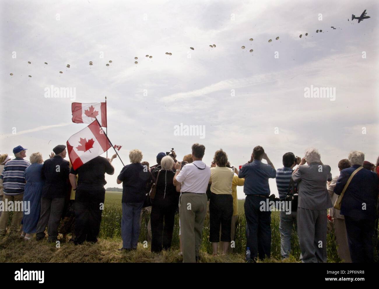 Onlookers watch as the 1st Canadian Parachute Battallion parachute from ...