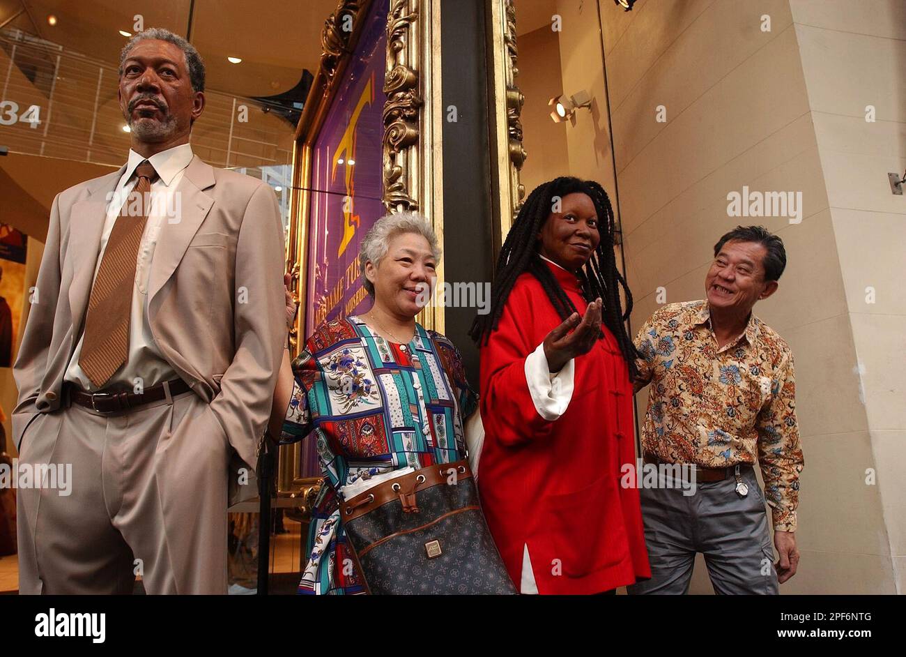 ** CORRECTS TO WHOOPI AND MADAME ** Ha Quach, center, and her husband ...