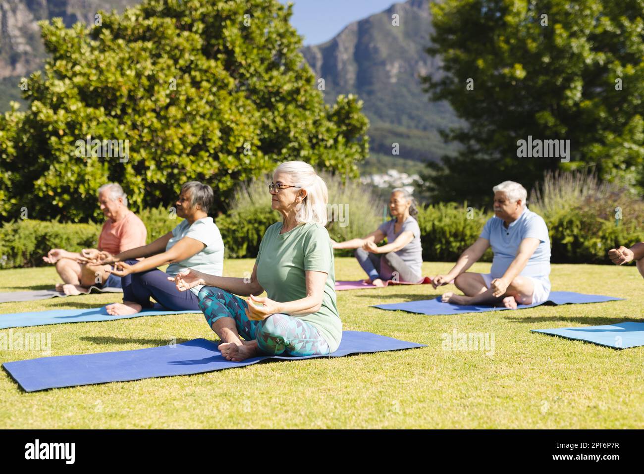 Happy diverse group practicing yoga hi-res stock photography and images ...