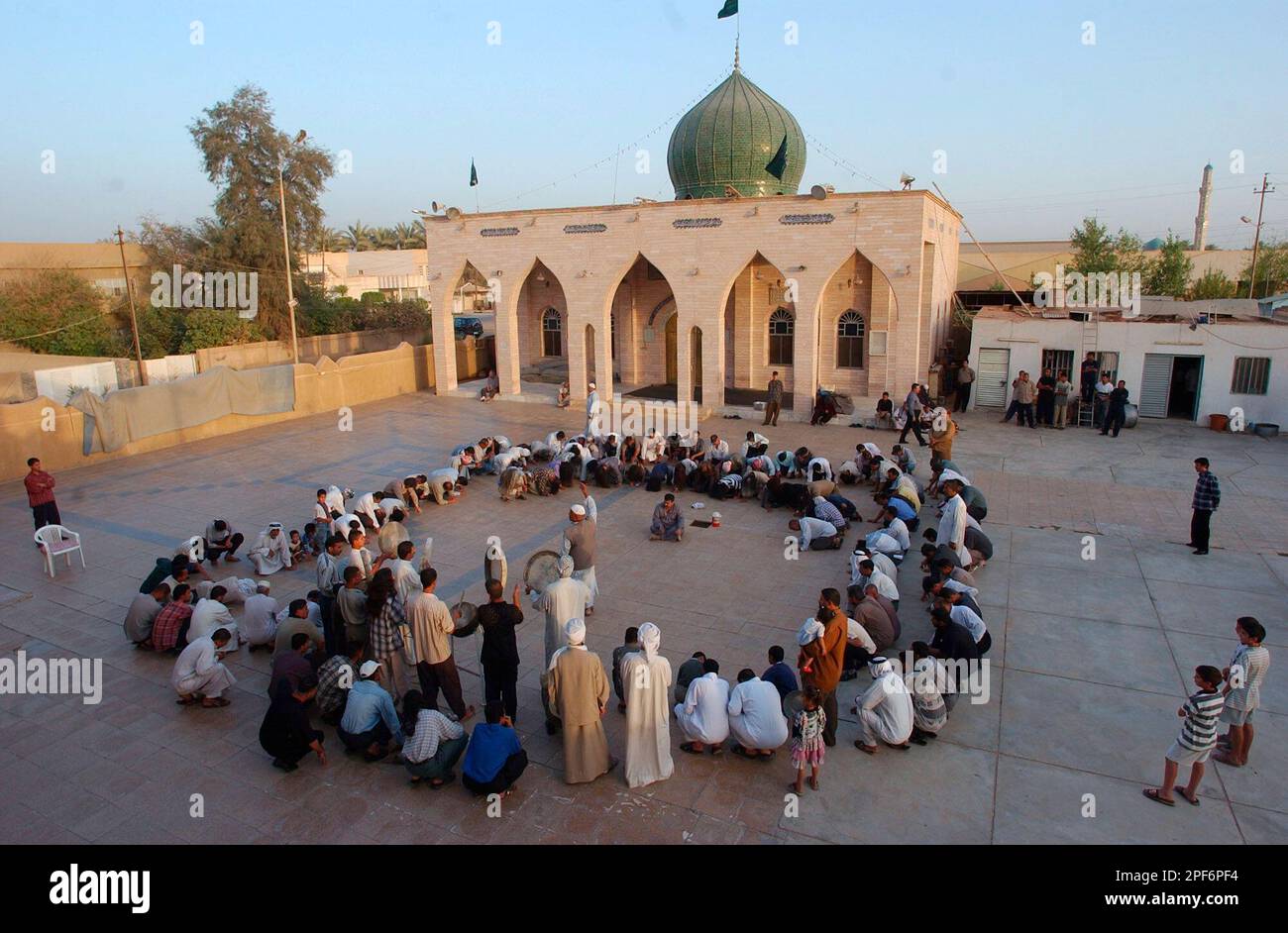 Iraqi men pray forming a circle at the sound of drums during a Sufi ...