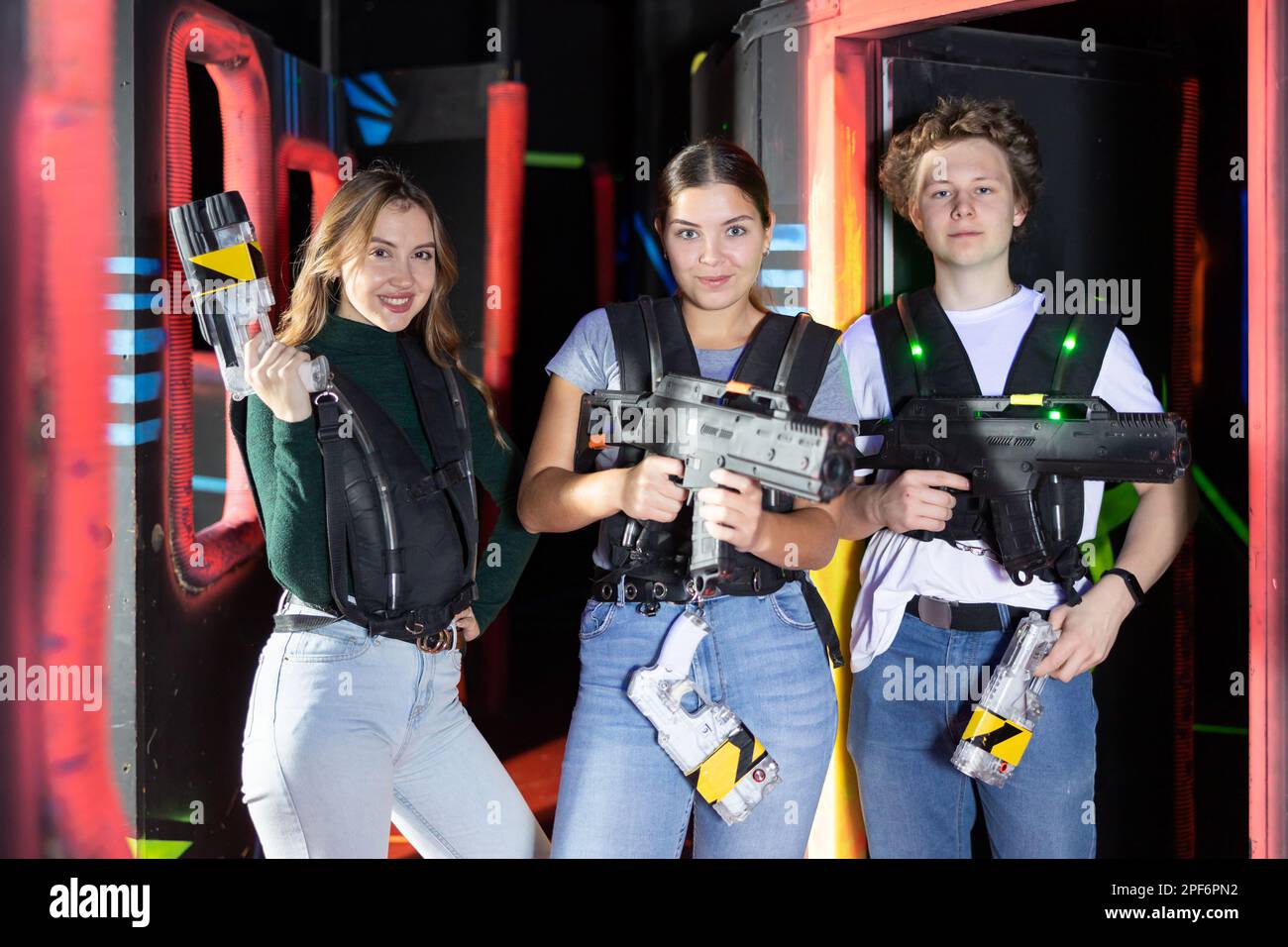 People posing with laser guns having fun on dark lasertag arena Stock ...
