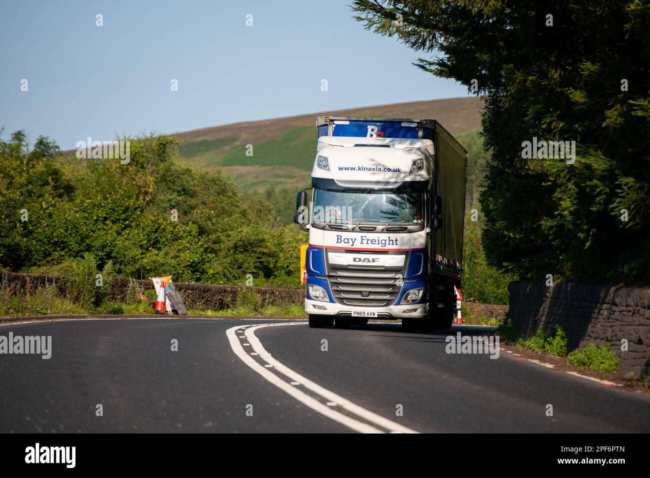 A DAF articulated truck pulling a curtainsider trailer heads towards ...