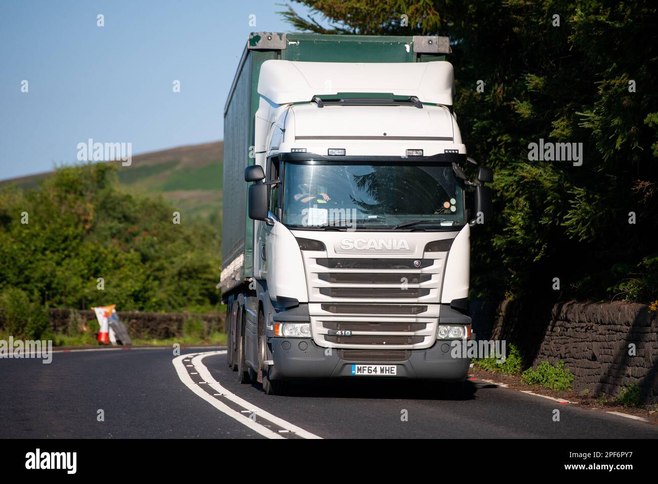 A Scania articulated truck pulling a curtainsider trailer heads towards ...