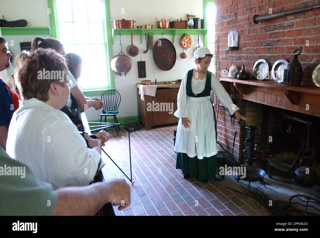 Docent Jessica Townsend talks to a tour group in a kitchen at the ...