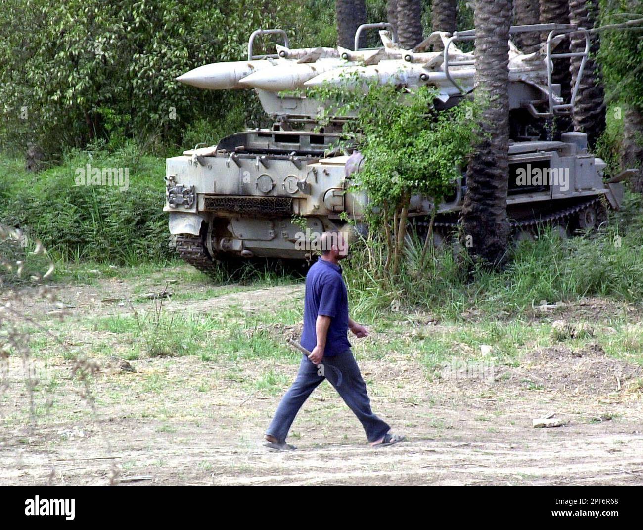 An Iraqi walks past an abandoned mobile launcher with SAM (surface-to ...