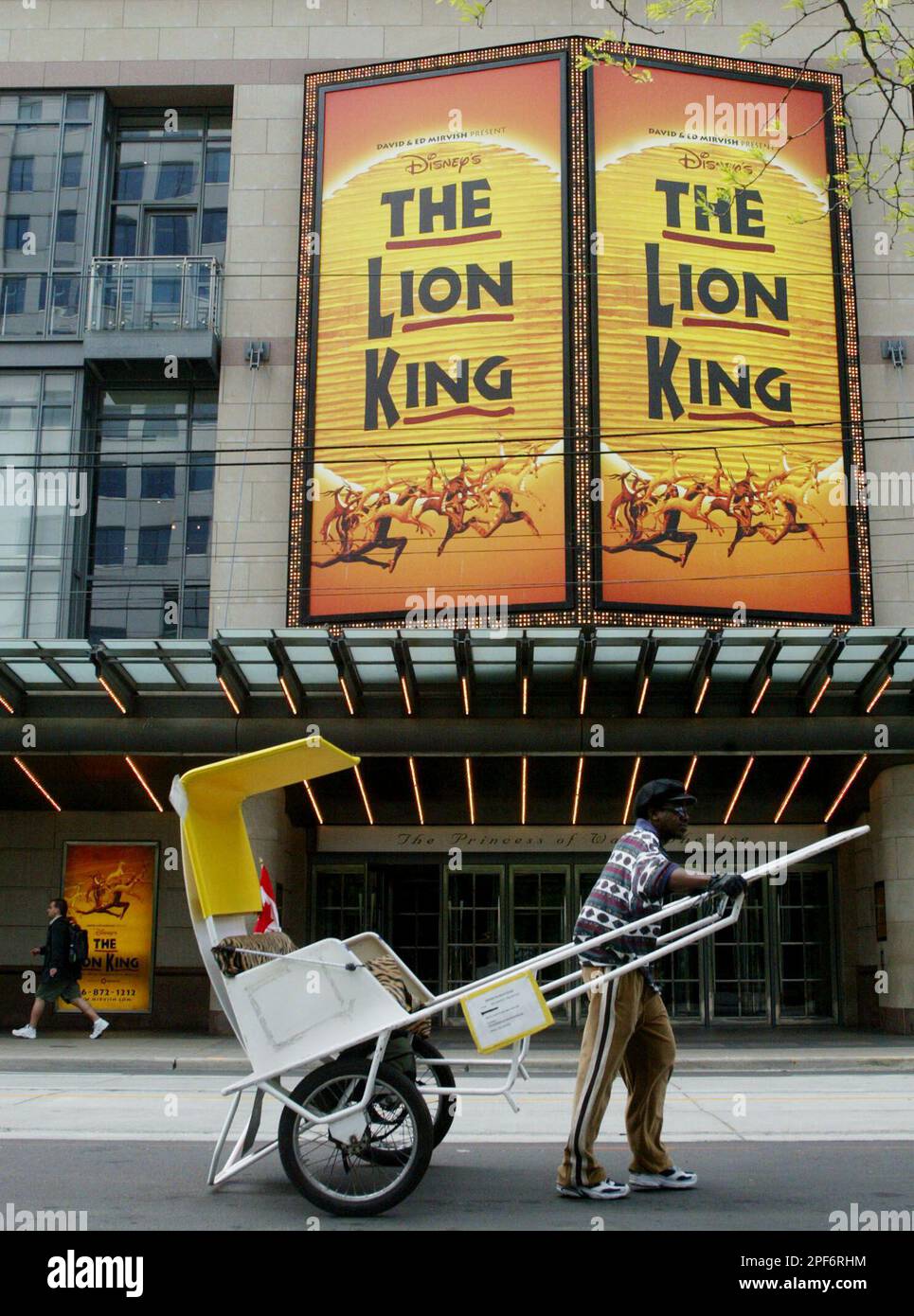 An empty rickshaw passes the Princess of Wales Theatre where "The Lion ...