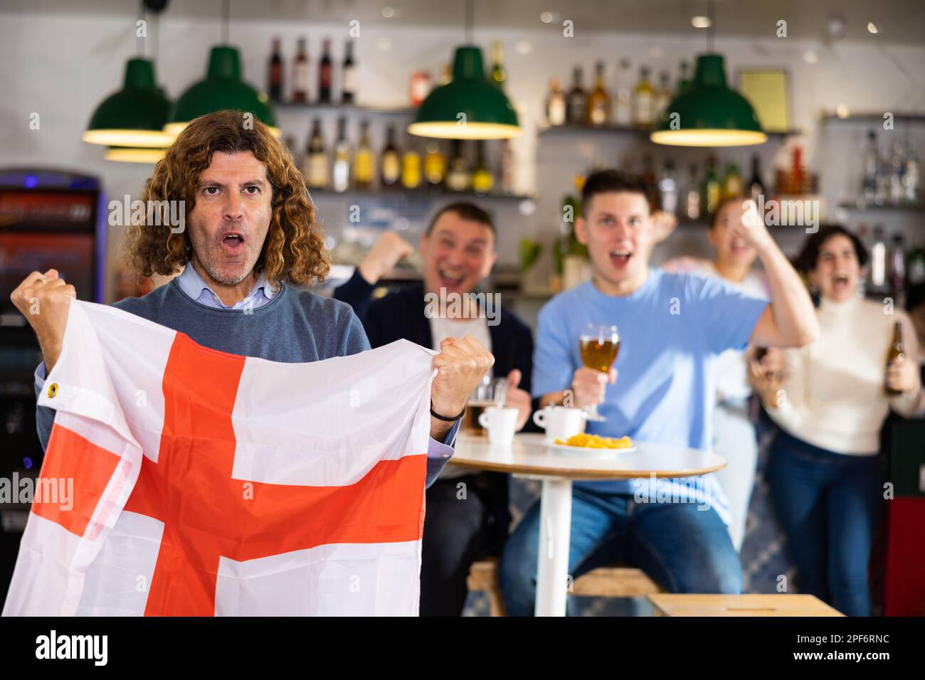 Group of people with England flag toasting with beer, having fun at ...