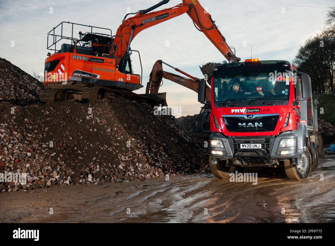 MAN TGS eight-wheel tipper being loaded by a Dousan dx140lc in a quarry ...