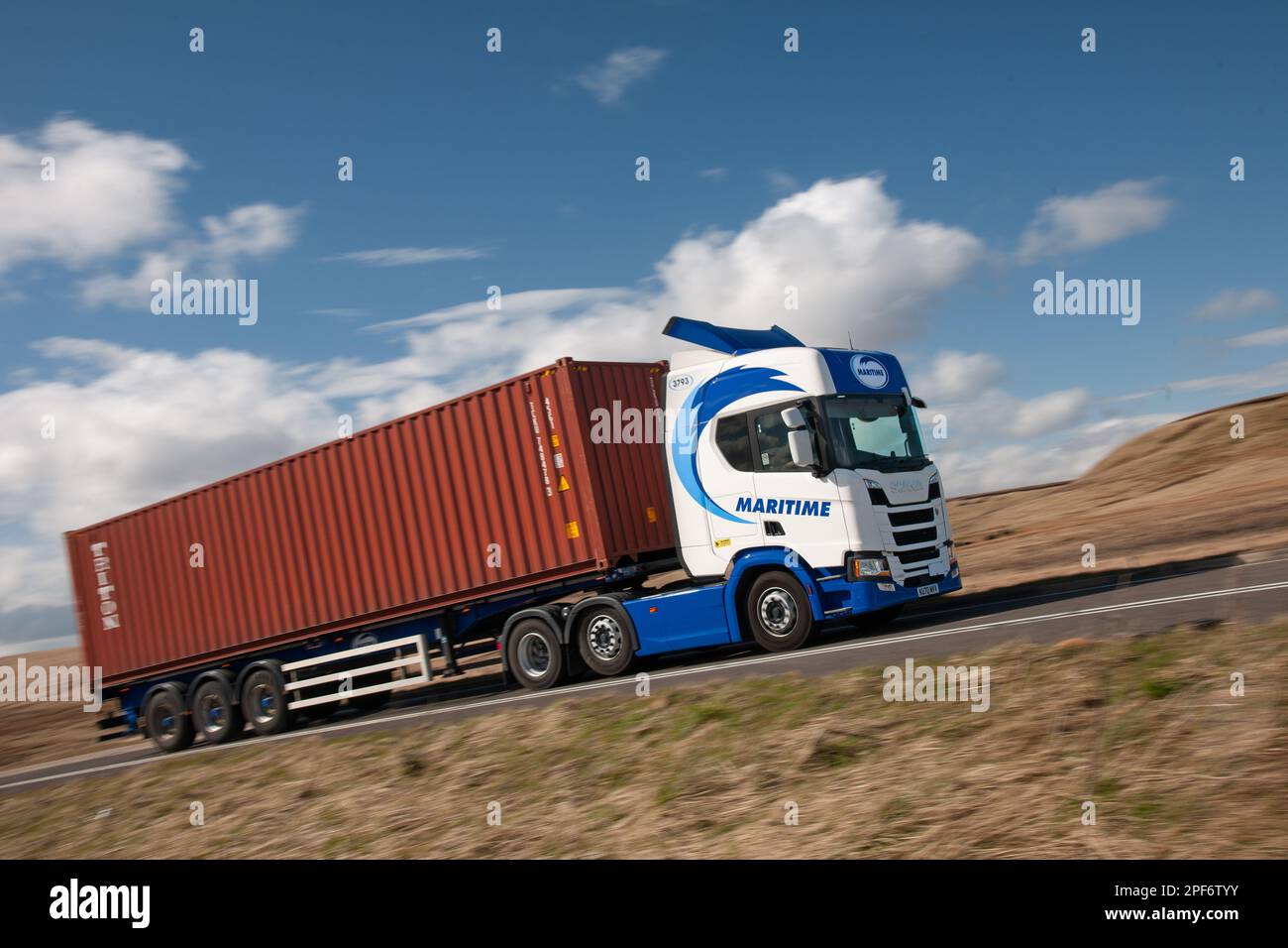A Maritime Group Scania truck pulling a trailer with a shipping ...