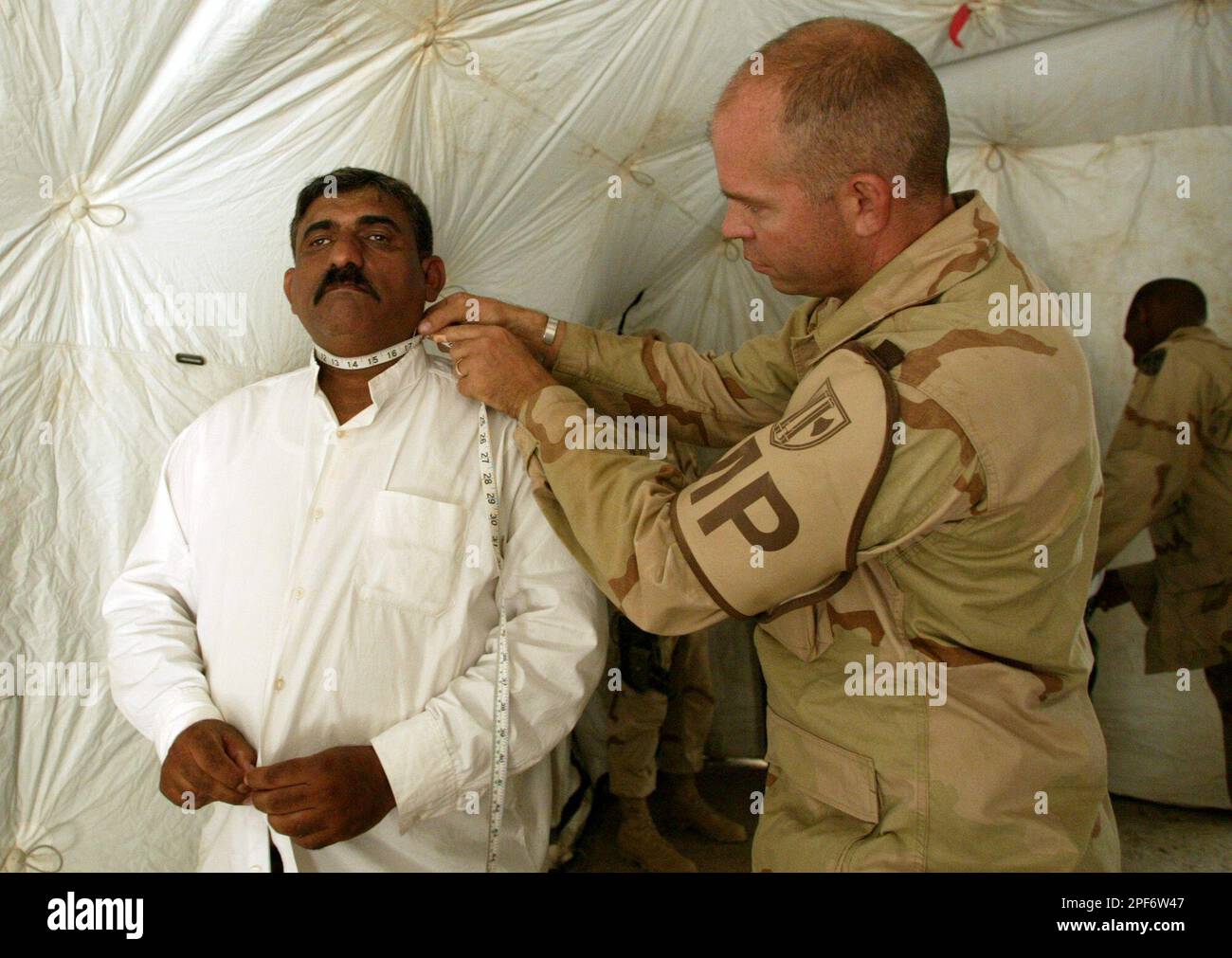 U.S. Army SFC Jonathan Stone of Kansas City, Mo., gets measurements of ...