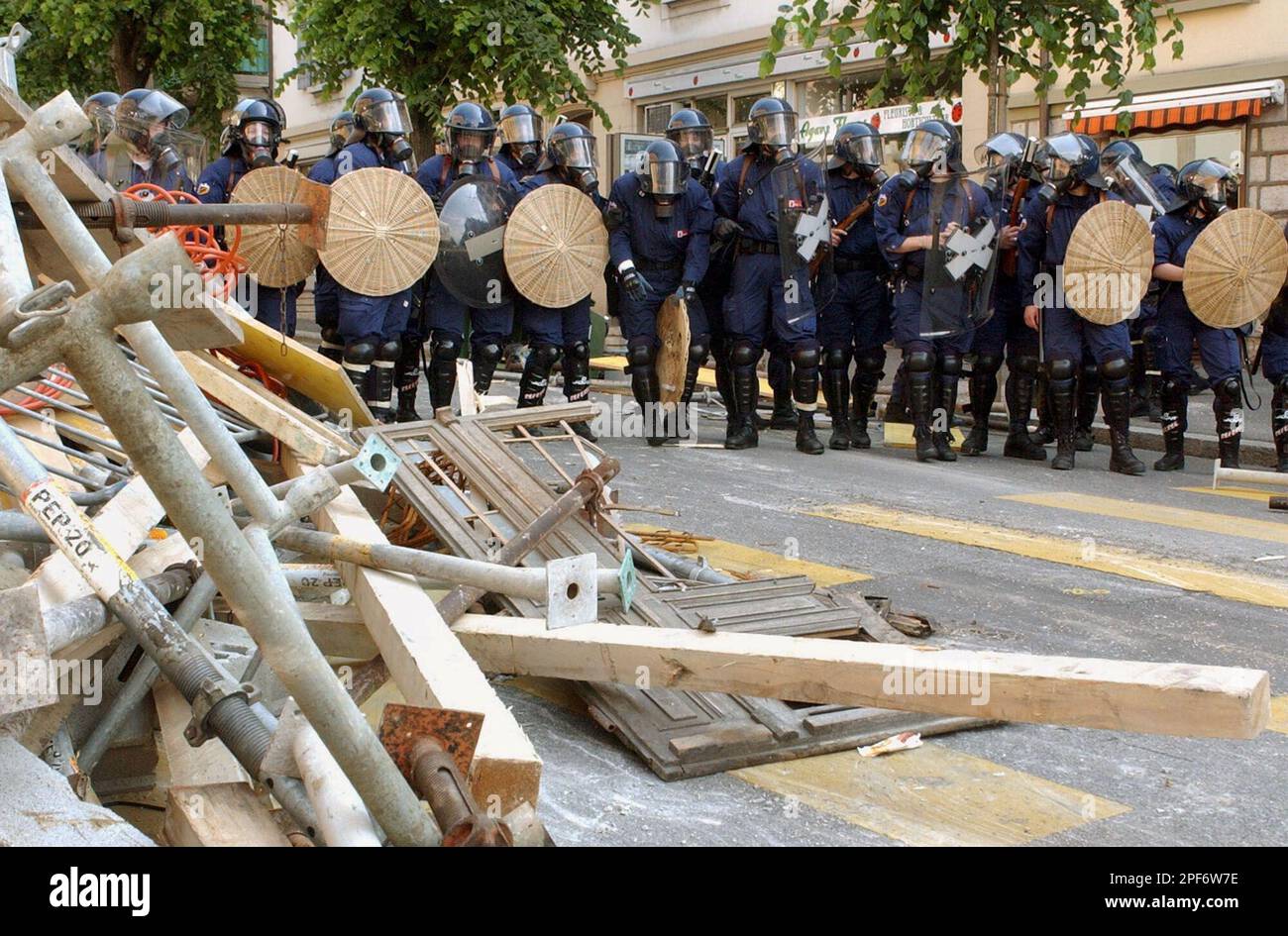 Riot police officers wait for anti-globalisation protestors during an ...