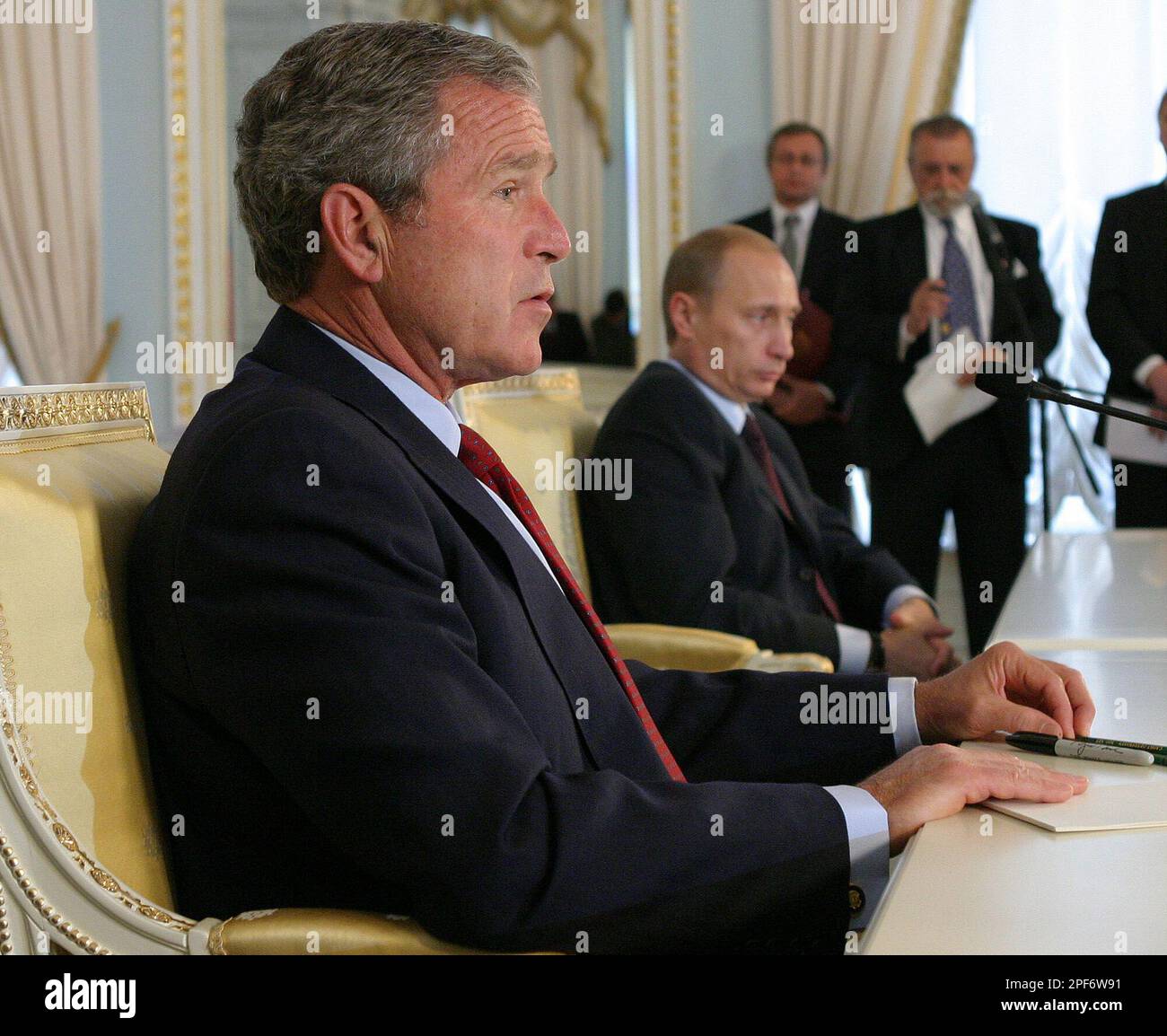 President Bush, left, answers questions during his joint news ...