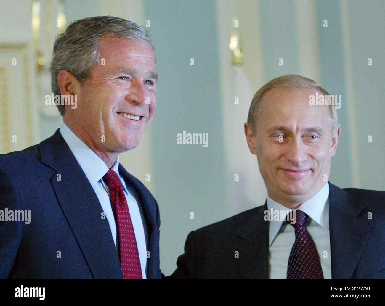President Bush, left, stands up with Russian President Vladimir Putin ...