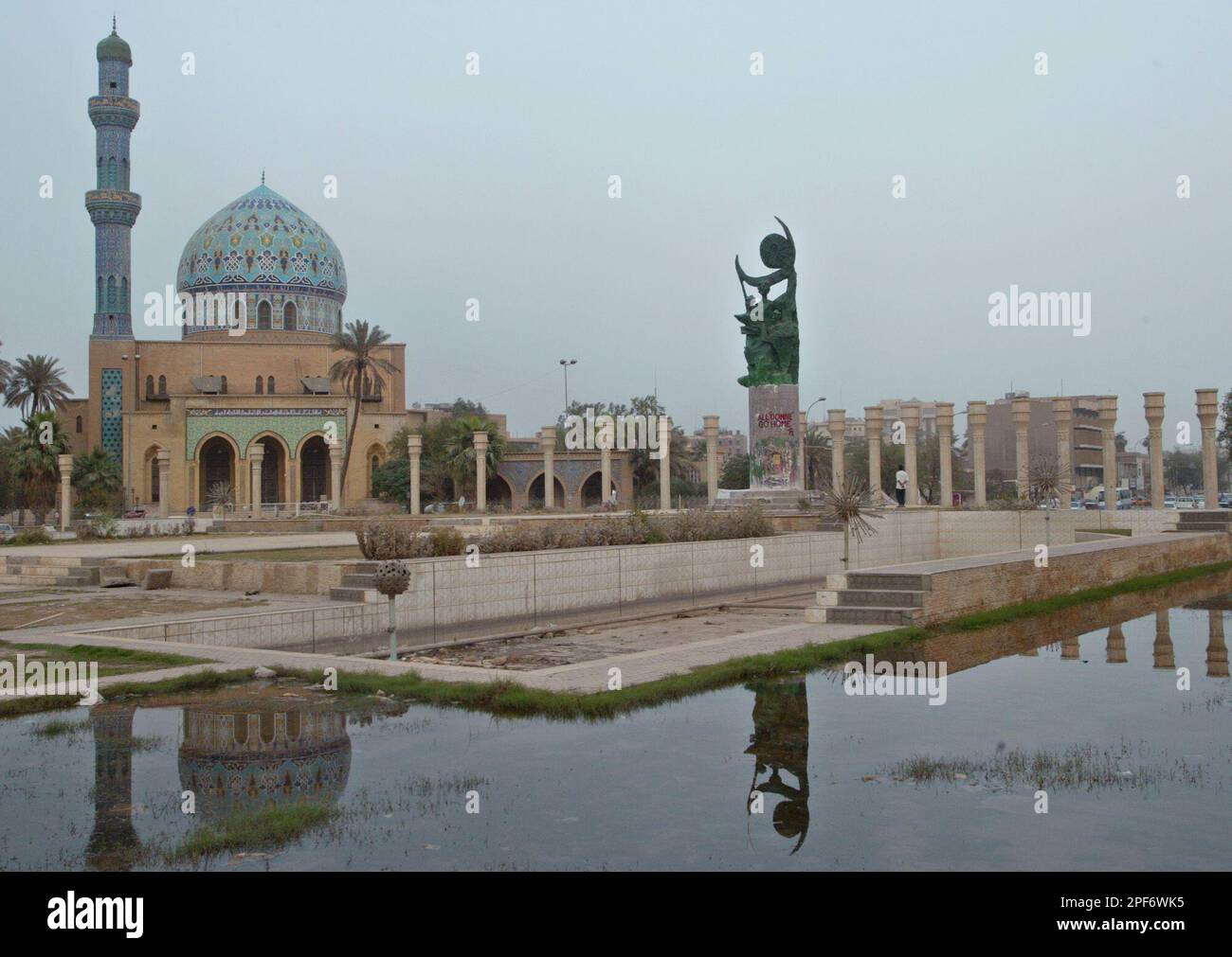 A statue featuring a central figure beneath a crescent moon stands atop ...