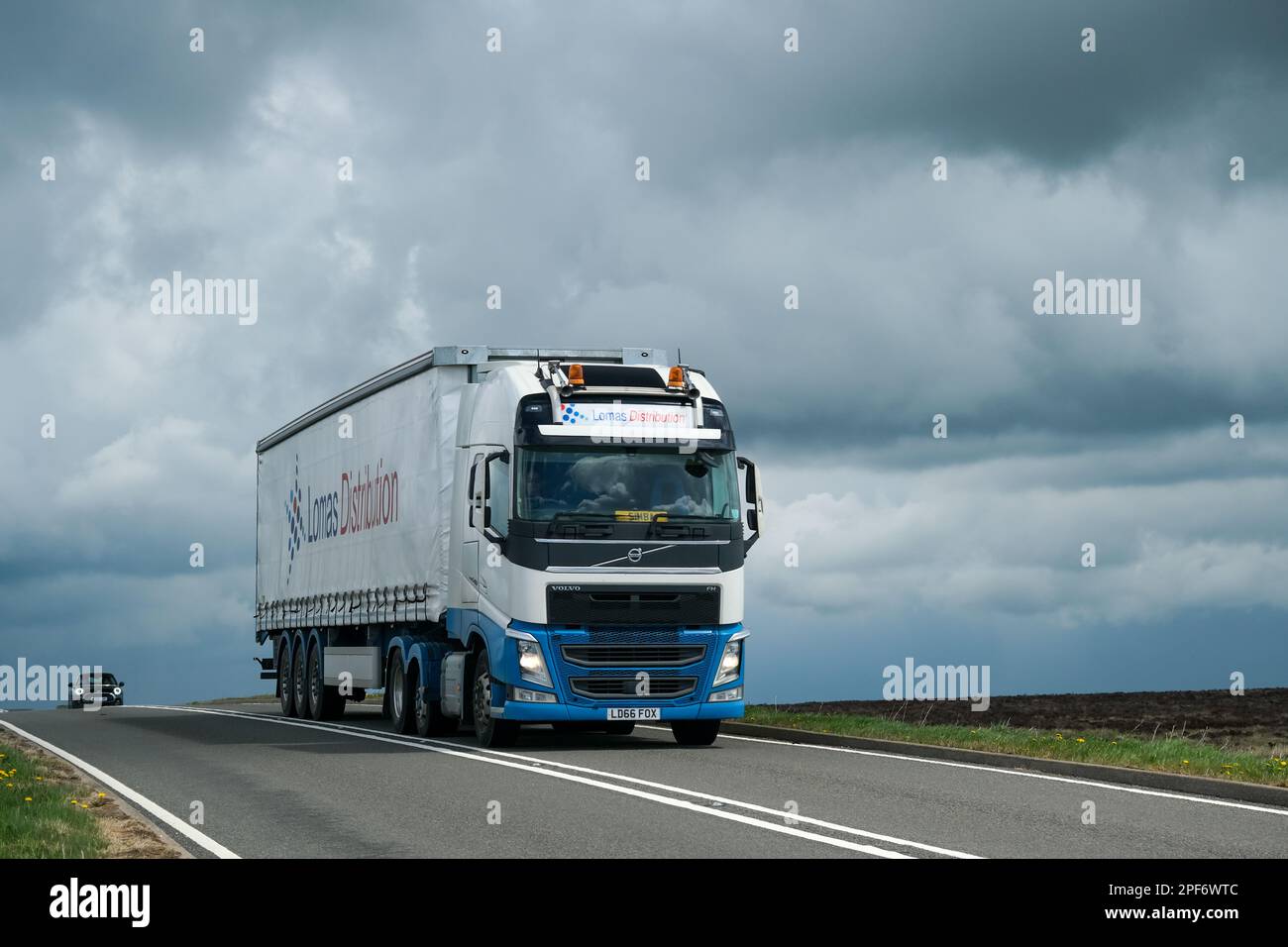 Volvo truck pulling certainsider trailer on a road across the Yorkshire ...