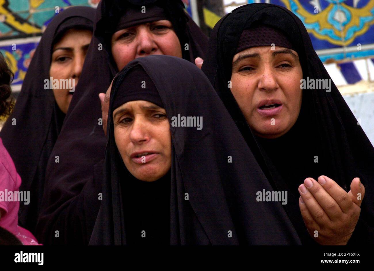 Iraqi women pray at the Imam Hussein Mosque in Karbala, 60 miles from ...