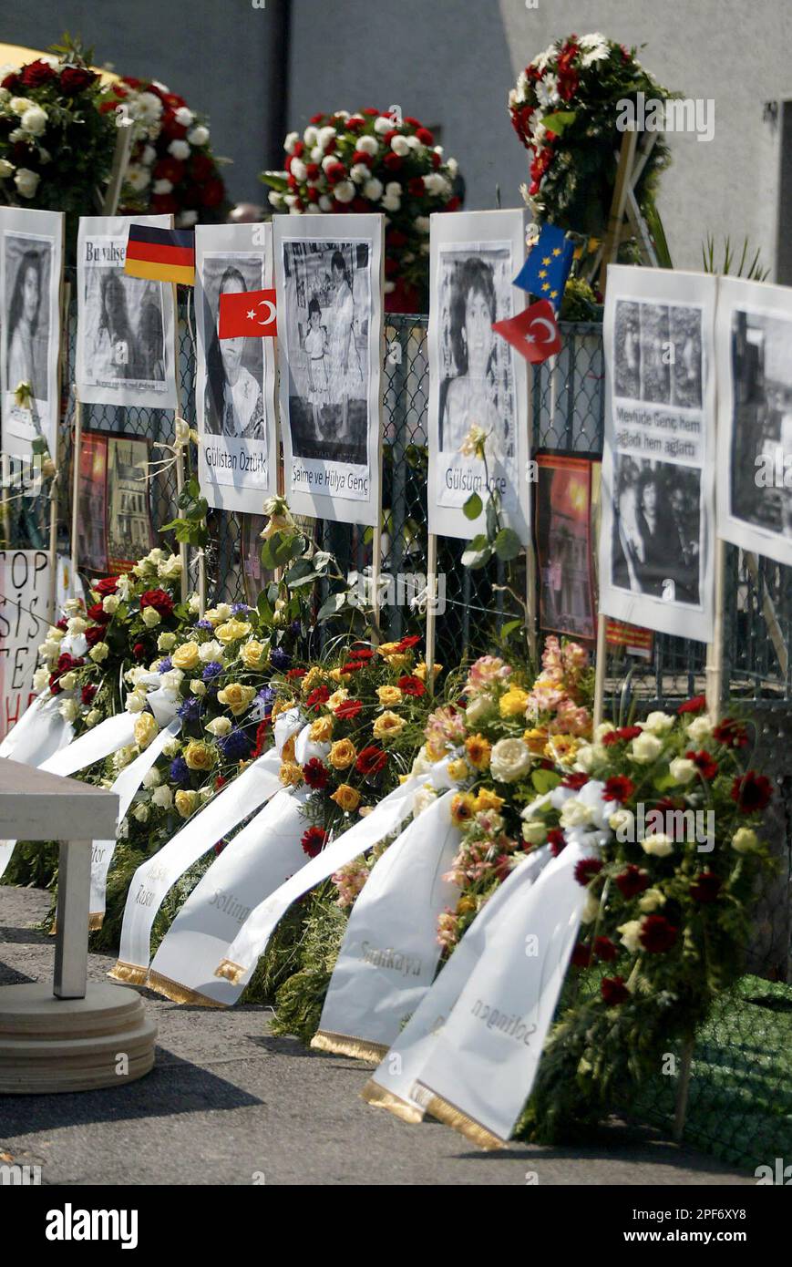 Flowers and pictures are left to remember the five dead Turkish victims ...
