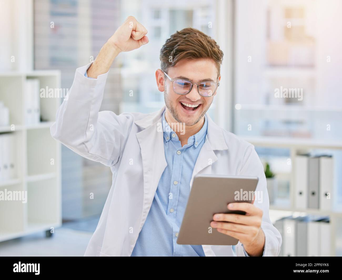 Success, medical and tablet with doctor in hospital and cheering for ...