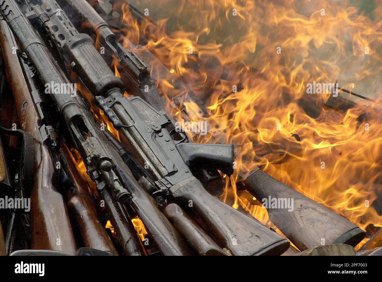 A bunch of rifles melting away in a blazing furnace. Over 5,000 ...