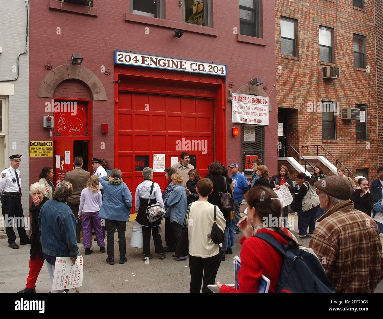 People gather around the entrance to the firehouse for Brooklyn Engine ...