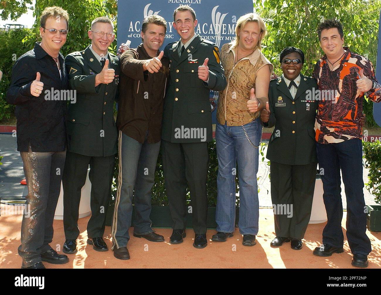 Former POWs Patrick Miller, second from left, Ronald Young Jr., center ...