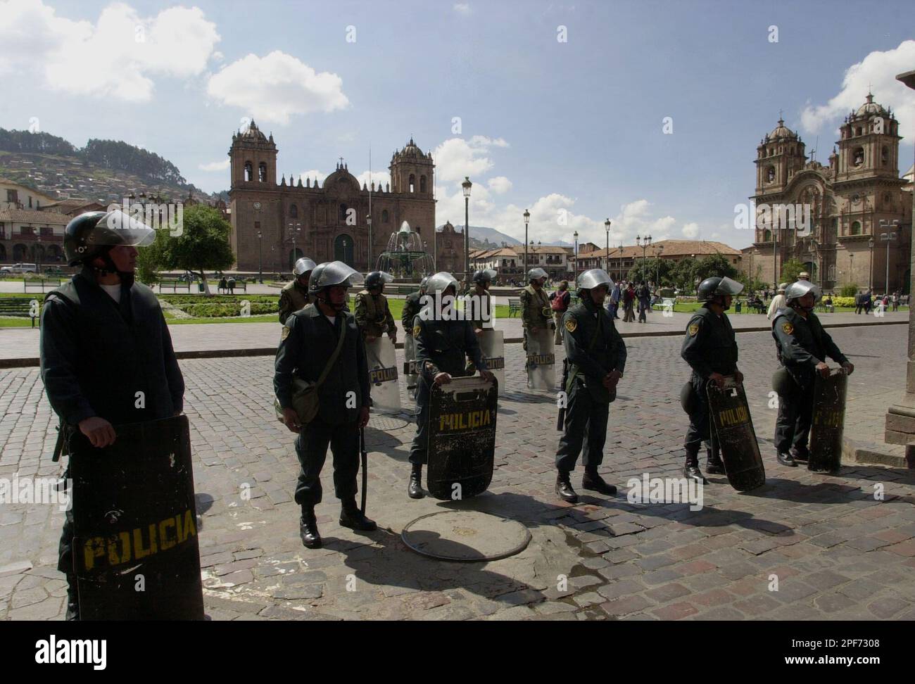 Peruvian police riot stand guard at plaza de armas in Cusco 350 miles ...