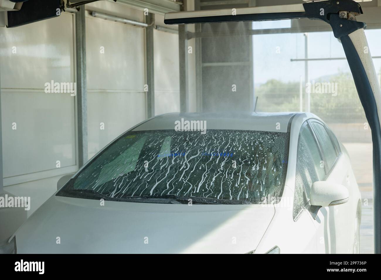 Car wash machine spraying water and detergent Stock Photo - Alamy
