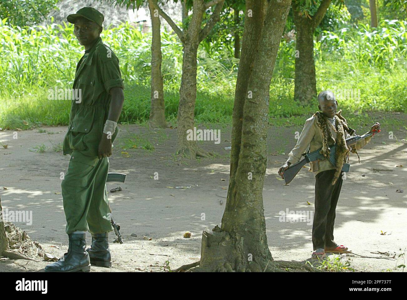 Lendu militia fighters one of them a young boy stand at a Lendu camp ...