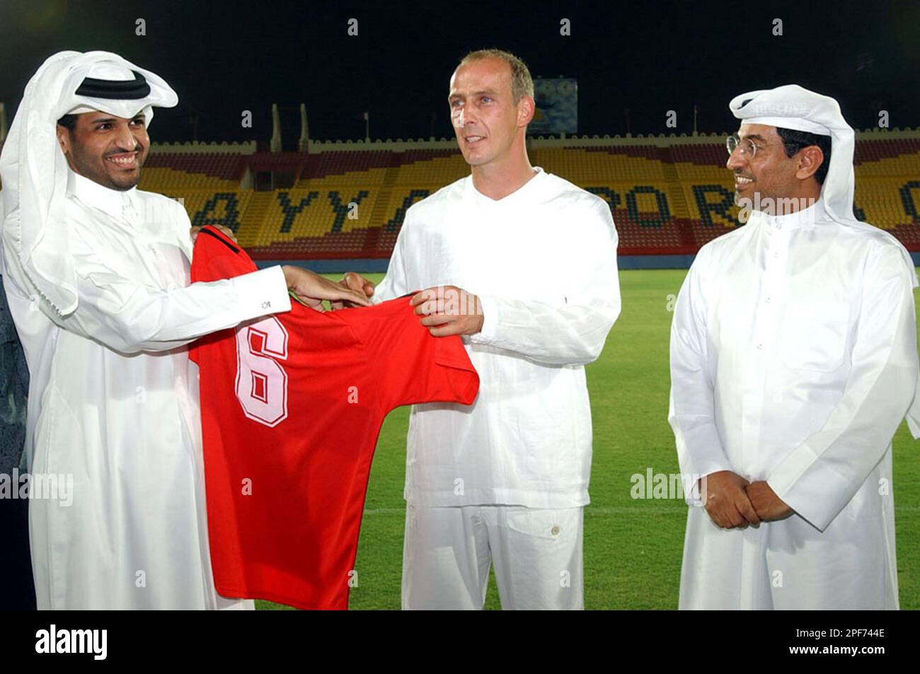 German soccer player, Mario Basler, centre, holds the number six T ...