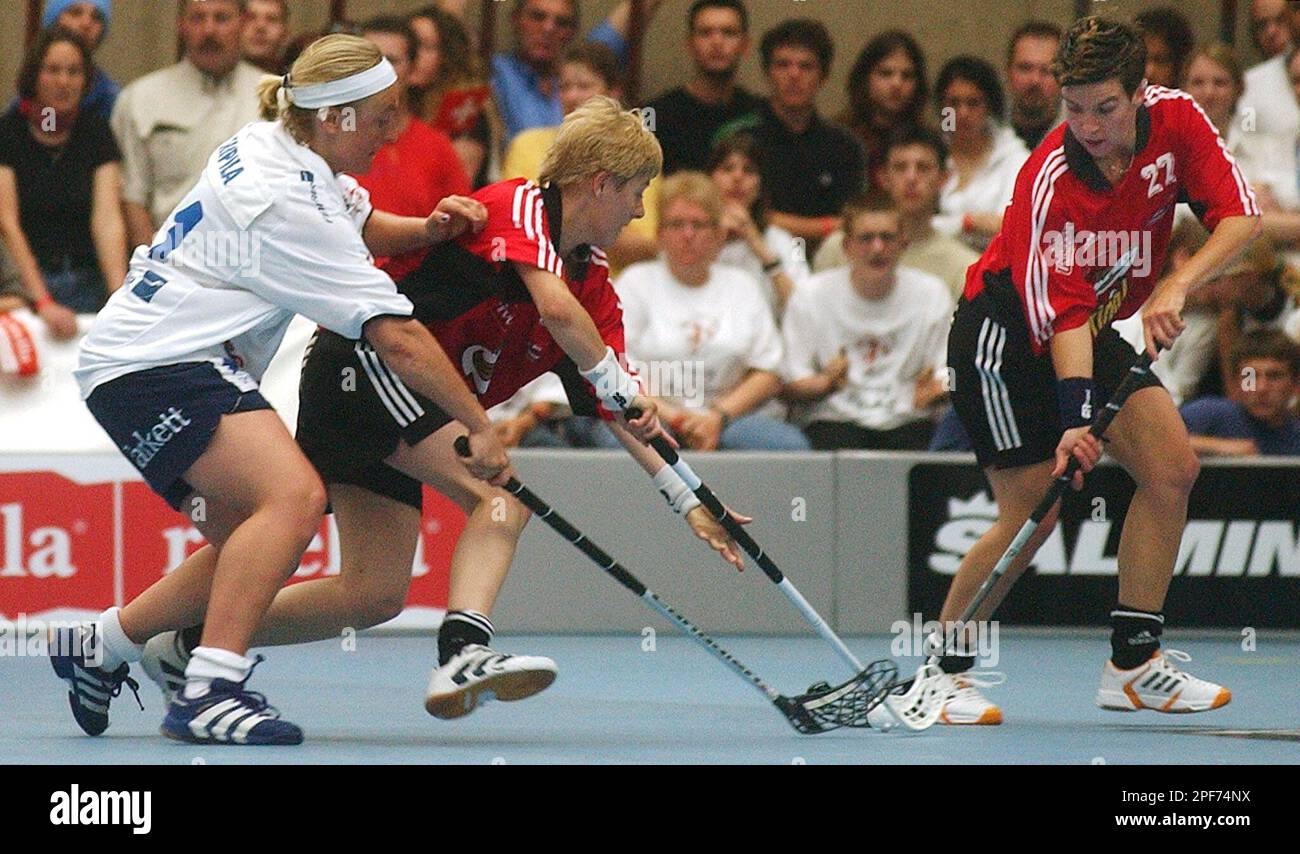 Swiss Petra Kundert, center, and Simone Berner, right, battle against ...