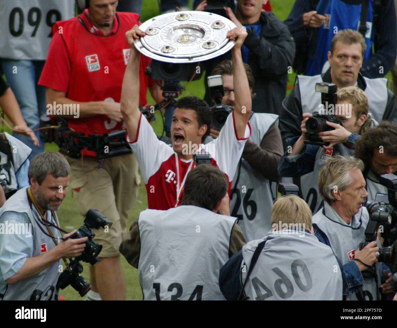 Munich striker Michael Ballack raises the trophy as he celebrates ...